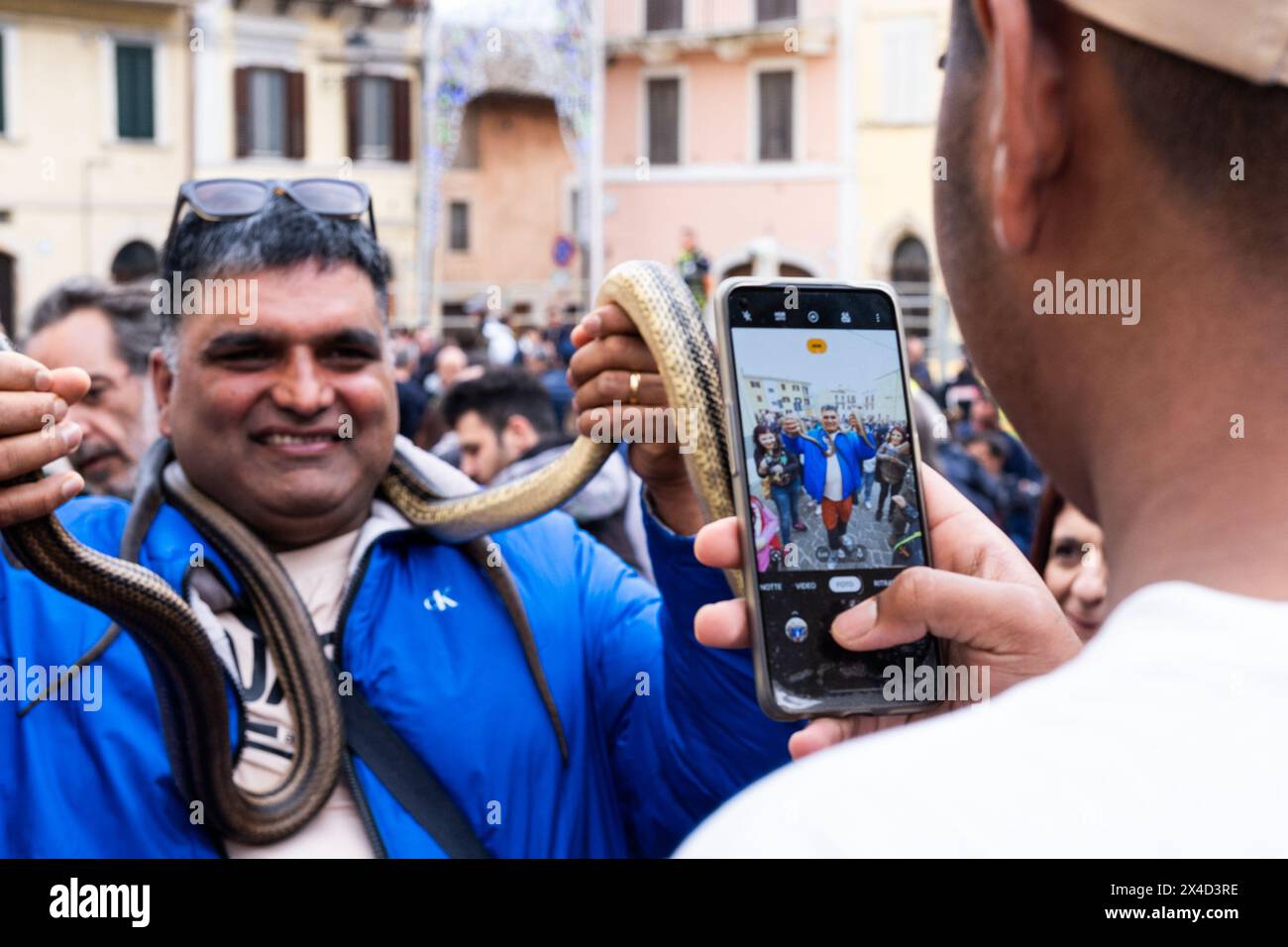 Saint Dominic, surrounded by snakes, makes his way through the crowd to ...