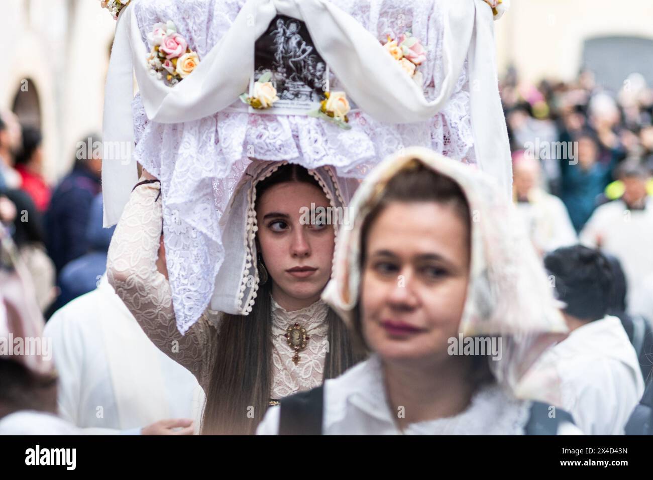 Women dressed in regional costumes parade in front of St Dominic ...