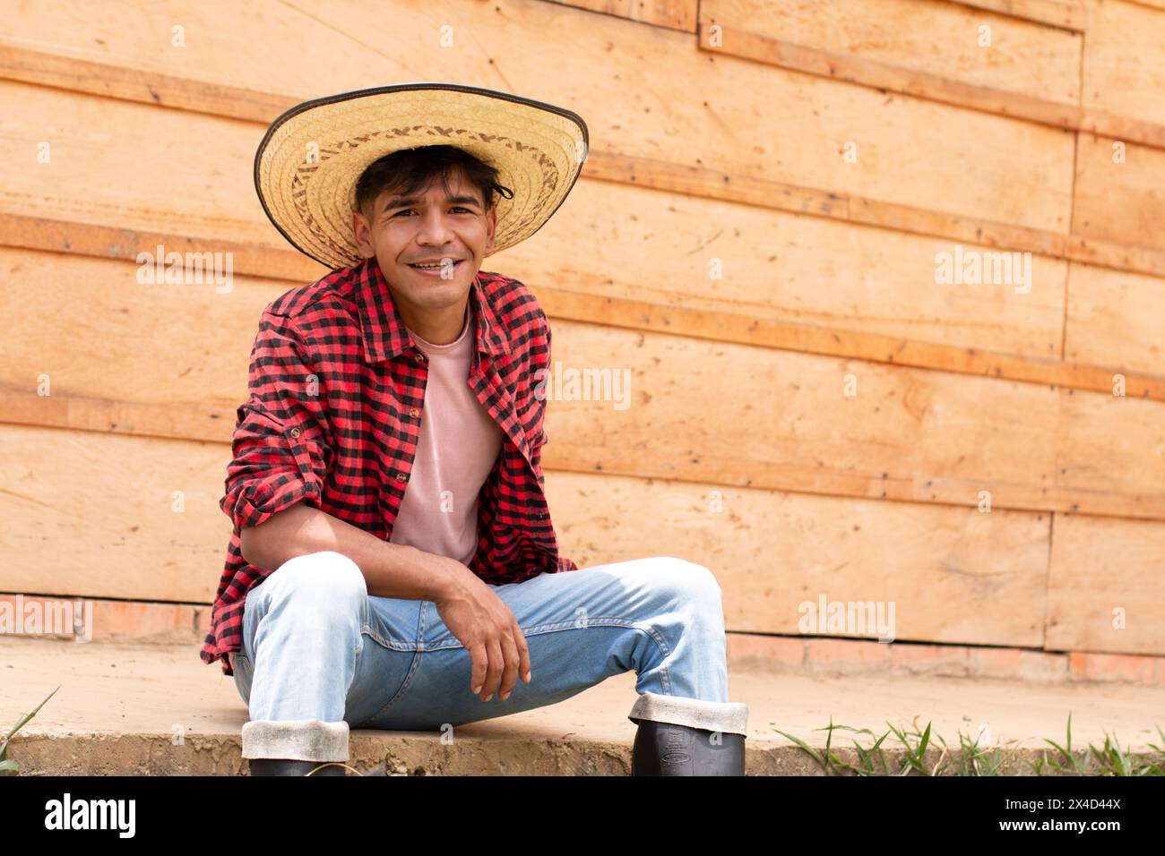 lifestyle: latin farmer sitting outside wood ranch Stock Photo - Alamy