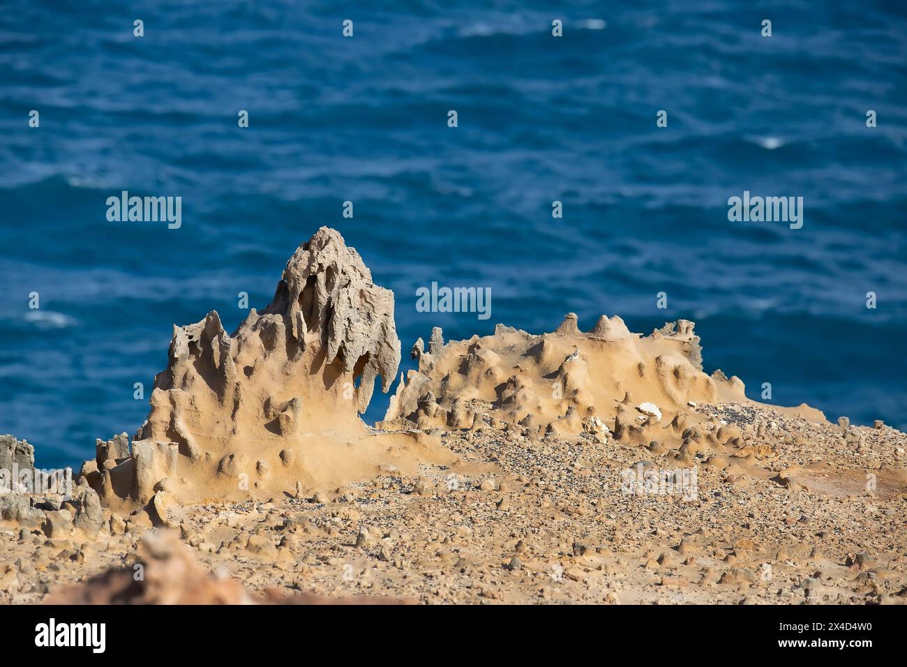 Unusual rock structure against the sea water background, coastline ...