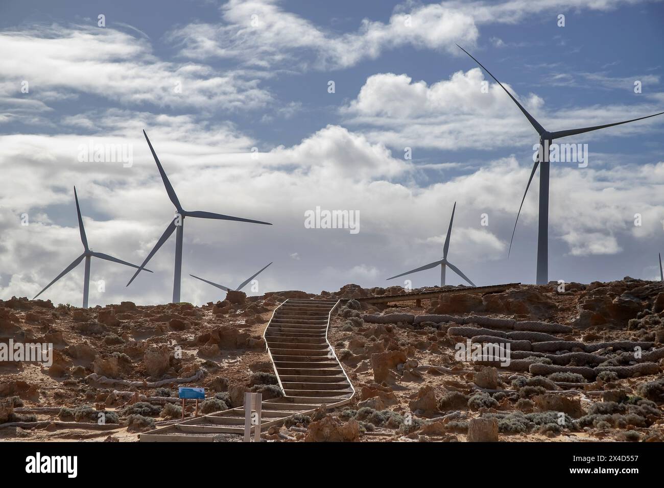 Wind turbines against the backdrop of a natural rad rocky landscape ...