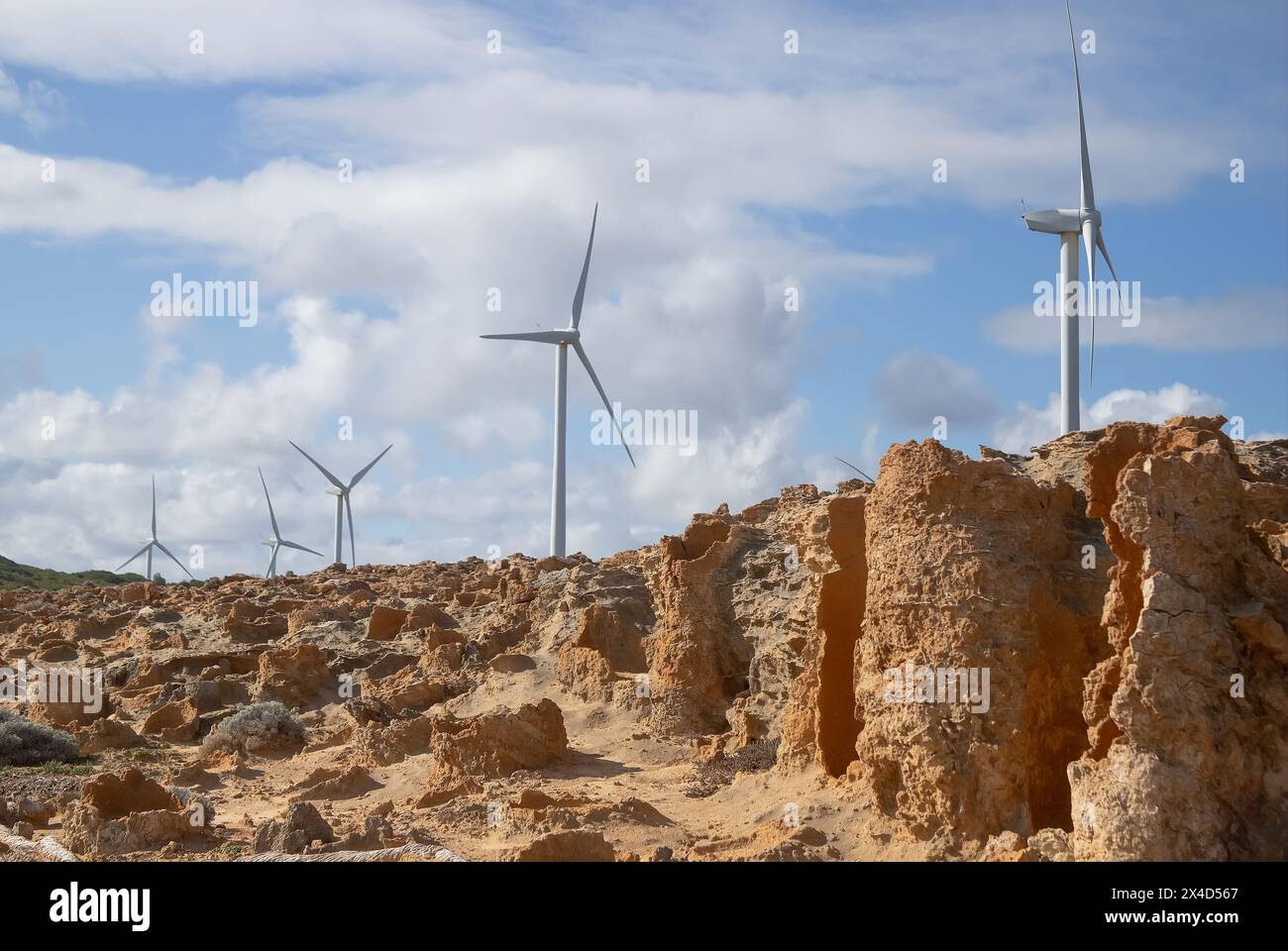 Wind turbines against the backdrop of a natural rad rocky landscape ...