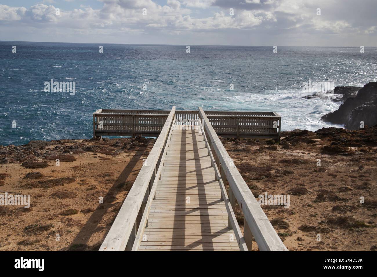 Jetty and observation lookout on the ocean coast, wooden pathway to the ...