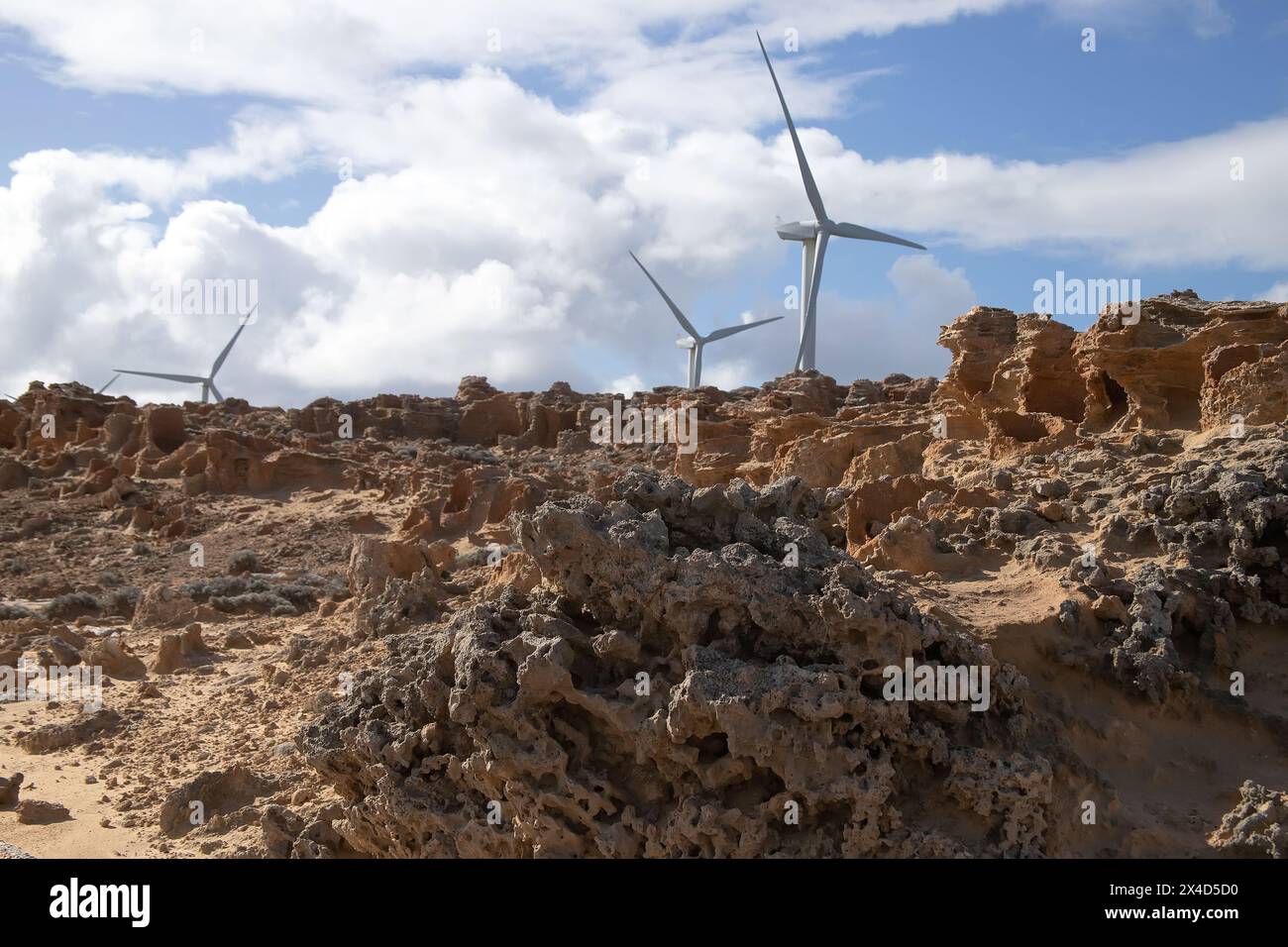 Wind turbines against the backdrop of a natural rad rocky landscape ...