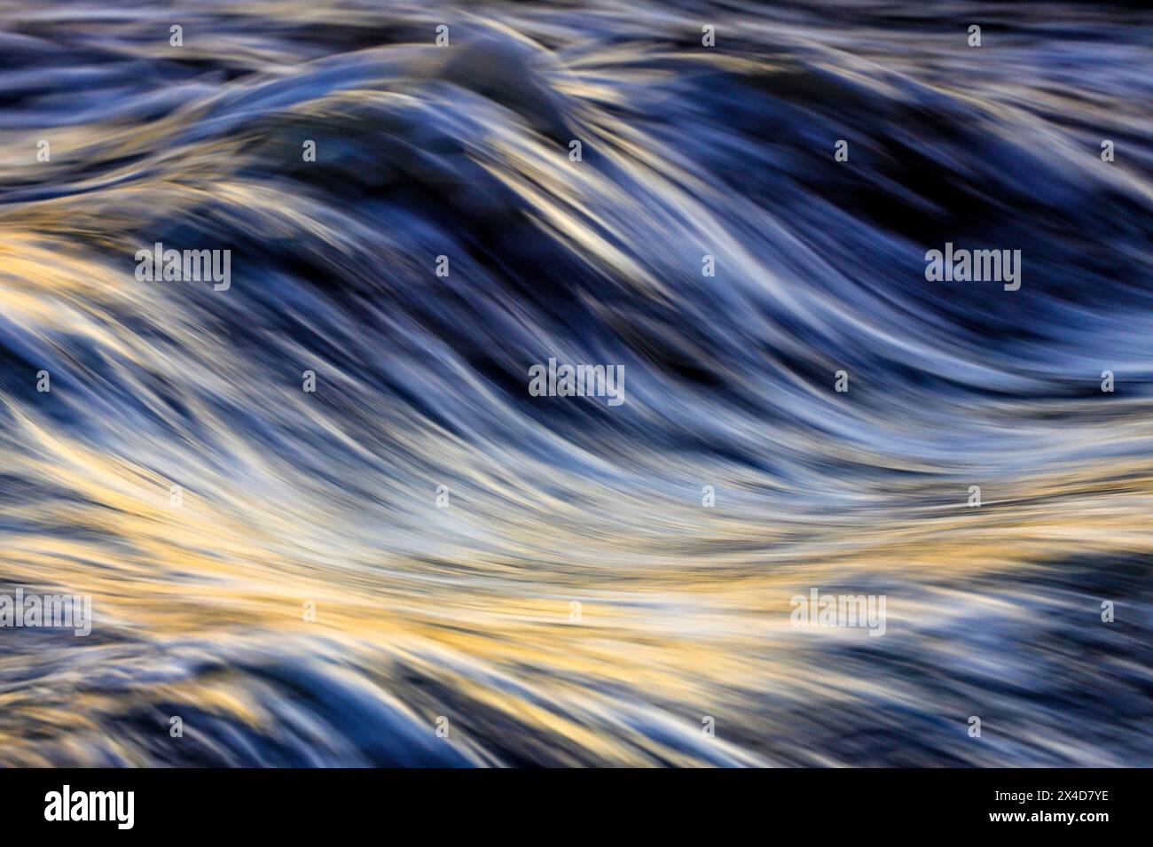 Fast moving water with slow shutter speed with warm sunset gold ...