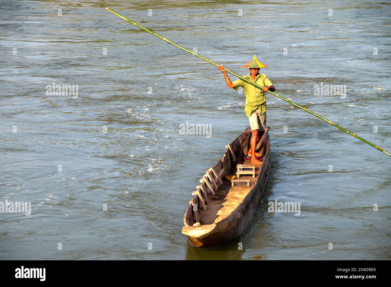 Nepal. Chitwan National Park, Sauraha, Nepali man navigating across ...