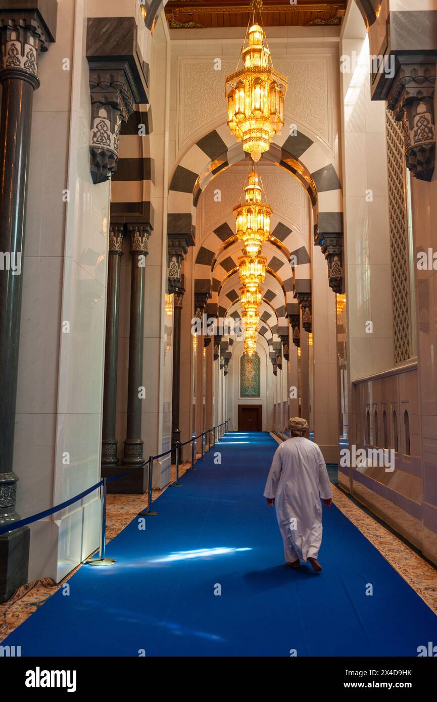 A man walking in the men's prayer room of the Sultan Qaboos Grand ...