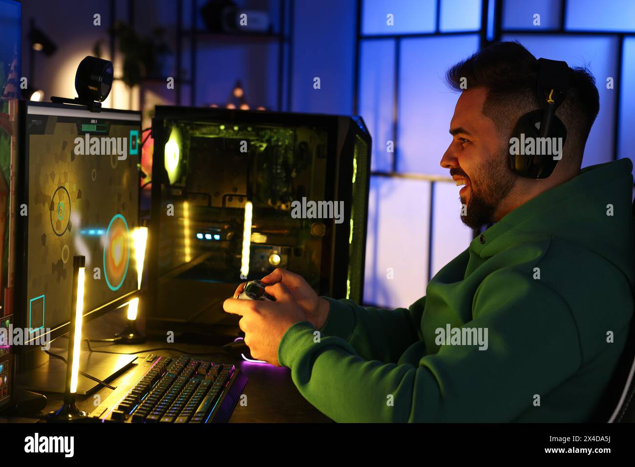 Man playing video games with controller at table indoors Stock Photo ...