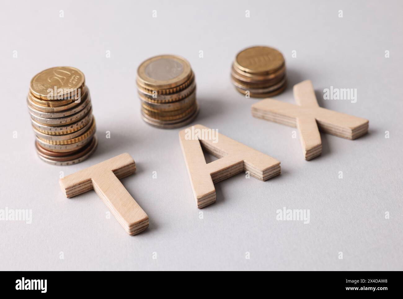 Word Tax made of wooden letters and coins on white background Stock ...