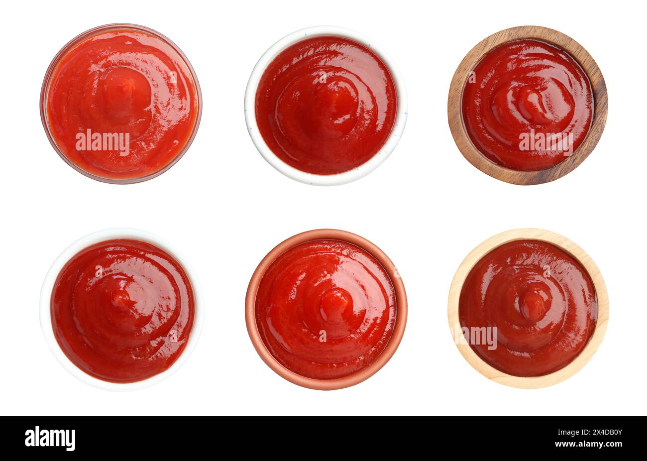 Set of tasty ketchup in different bowls isolated on white, top view ...