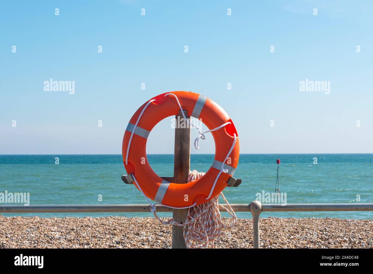 lifebouy, orange lifebouy by a beach and sea with blue sky Stock Photo ...