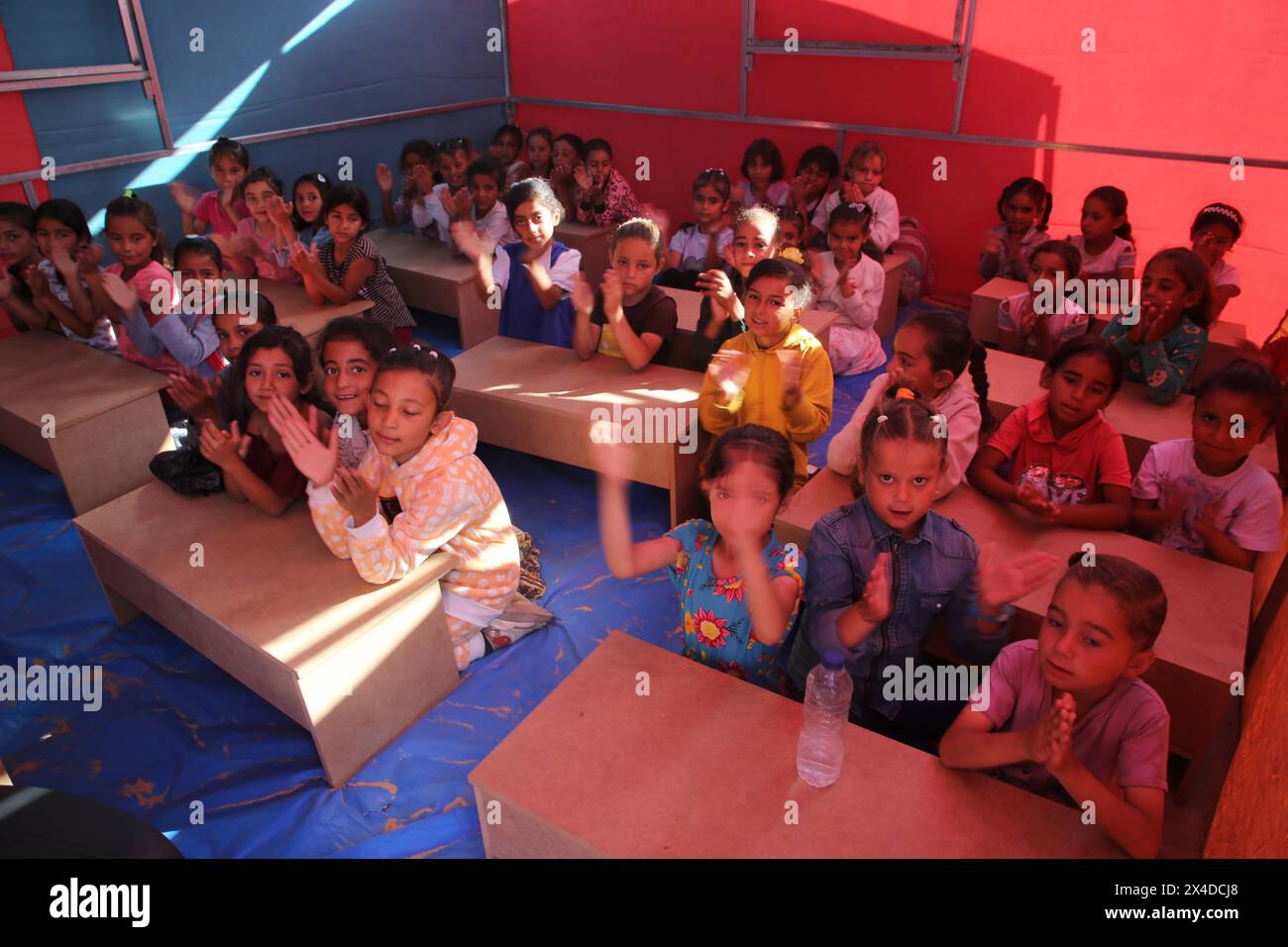 Palestinian children deprived of their right to education attend classes at tent school due the ...