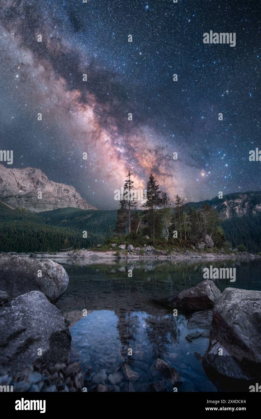 Majestic night scenery with the Milky Way reflected in a mountain lake ...