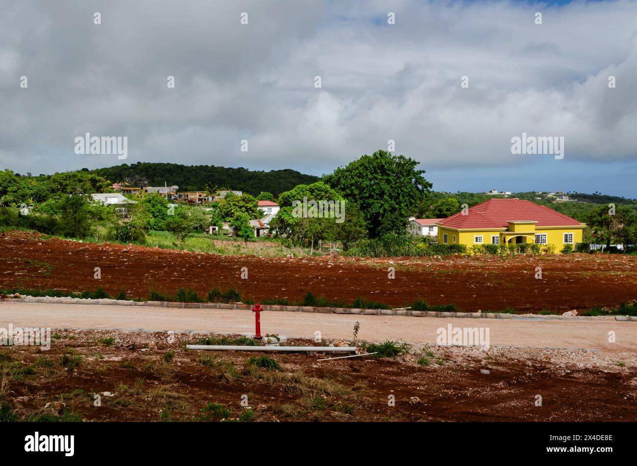 Red Soil Landscape With White Road Stock Photo - Alamy