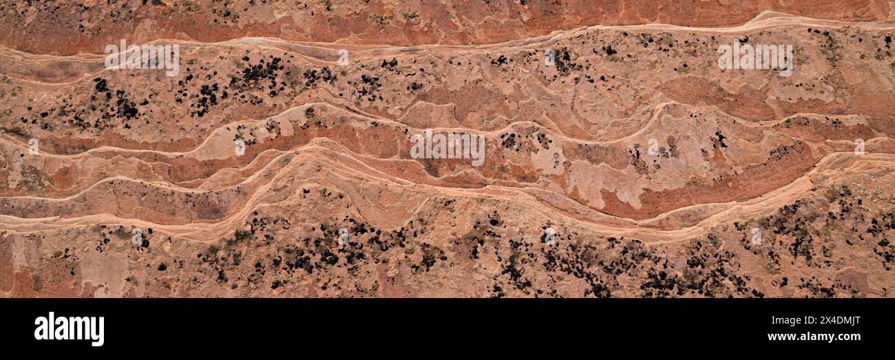 A section of ancient sandstone sediment showing eroded layers in a ...