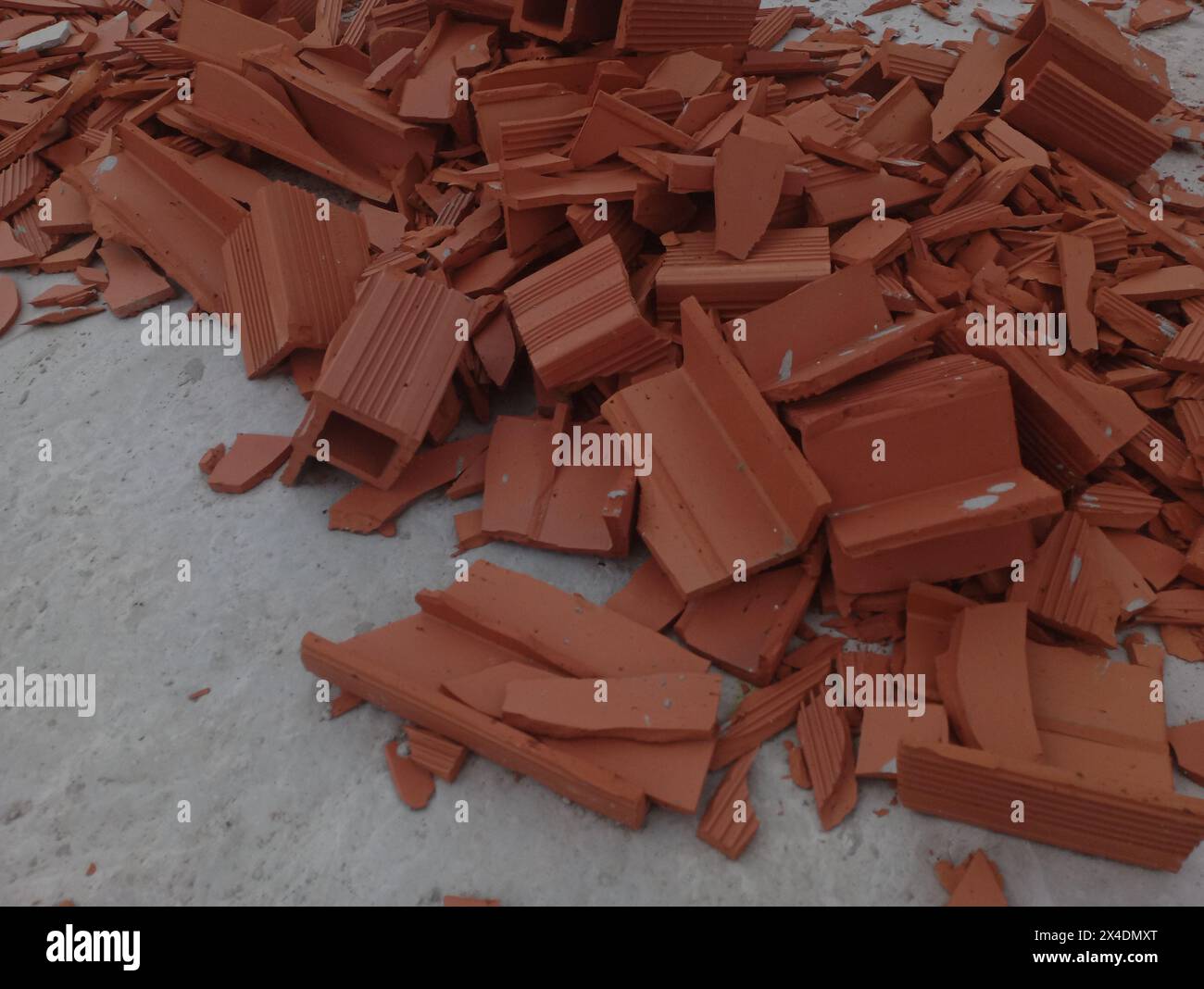 Red brick waste on the floor. Construction waste Stock Photo - Alamy