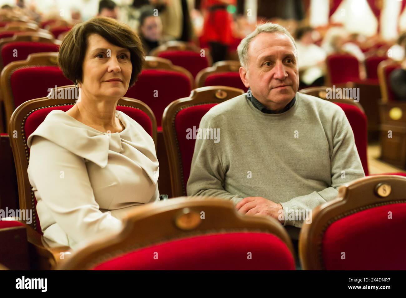 Elderly couple watching play in the theater Stock Photo - Alamy
