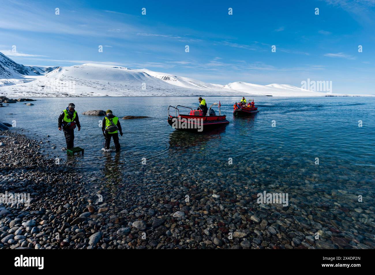 Ecotourists aboard inflatable rafts disembark on Bockfjorden's shore ...