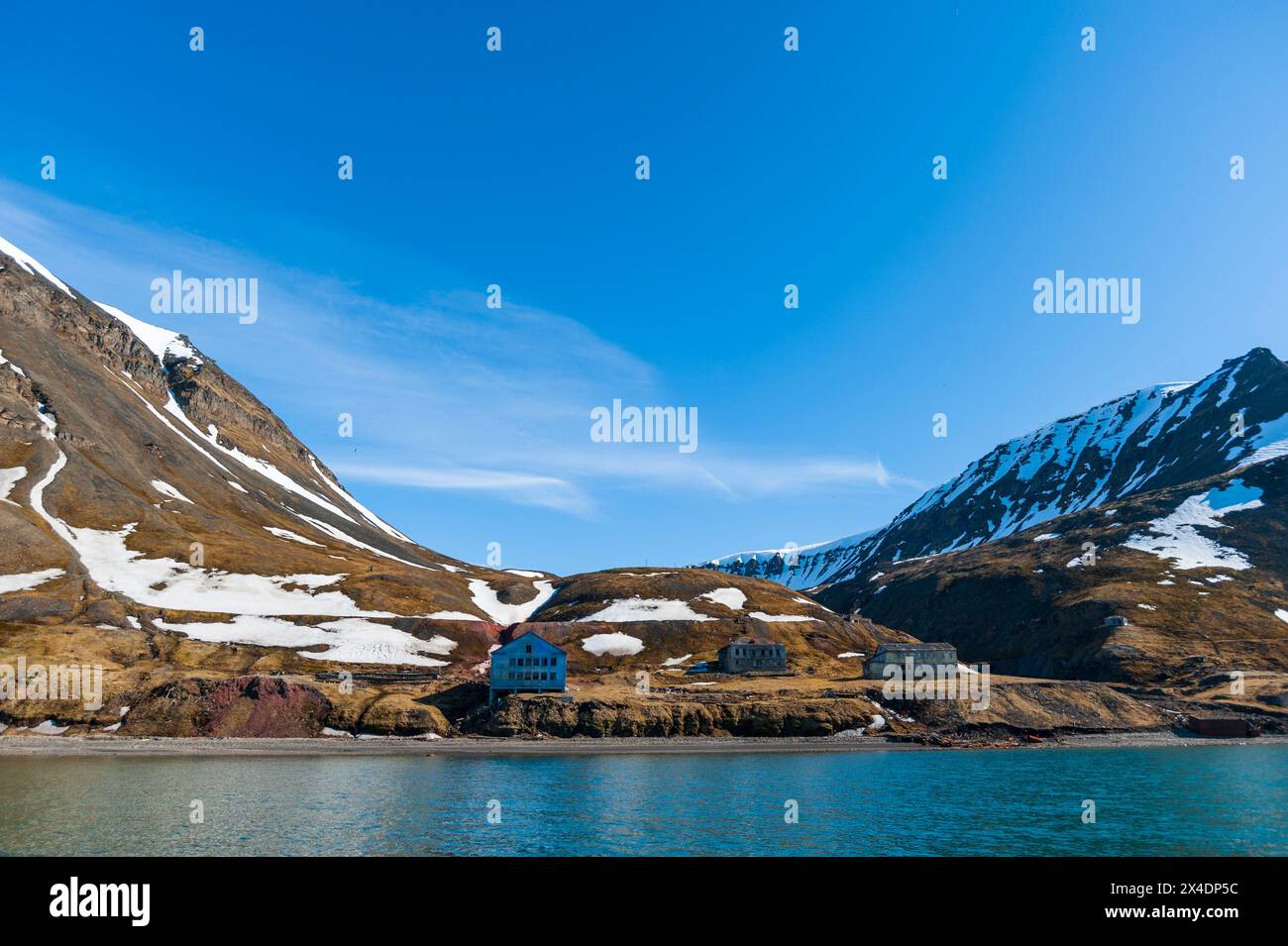 An old settlement nestled among cliffs near Longyearbyen on the bay of ...