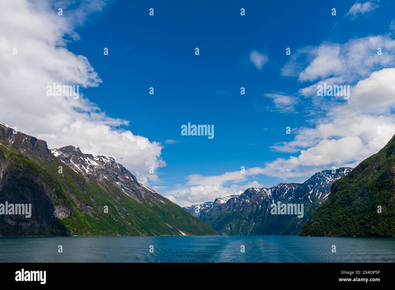 Steep rugged mountains rise up from the glacial waters of ...