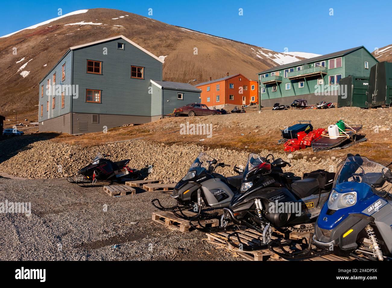 Colorful buildings and snowmobiles parked on pallets in downtown ...