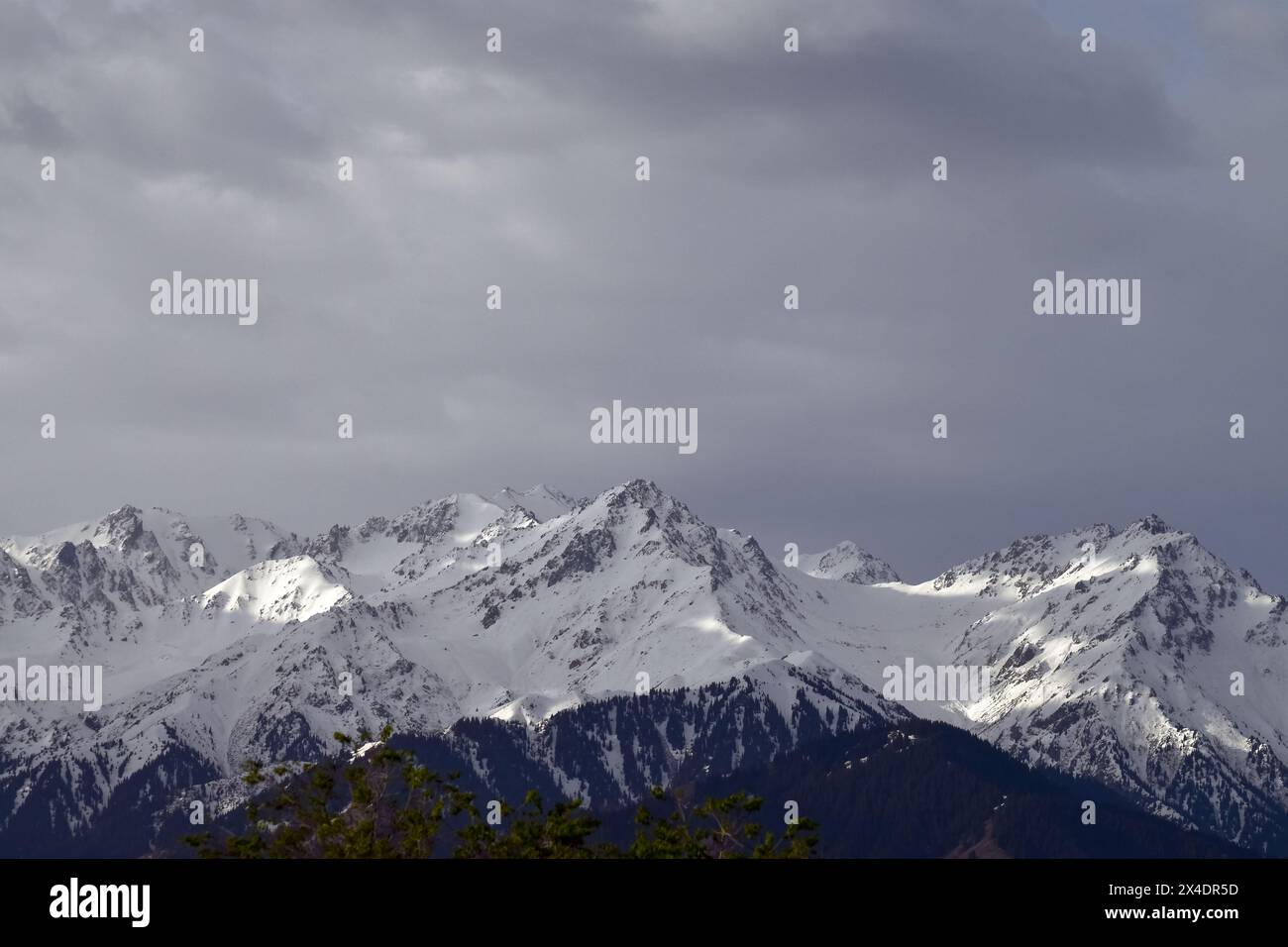 Snow covered mountains in cloudy weather, Tian Shan, large system of ...