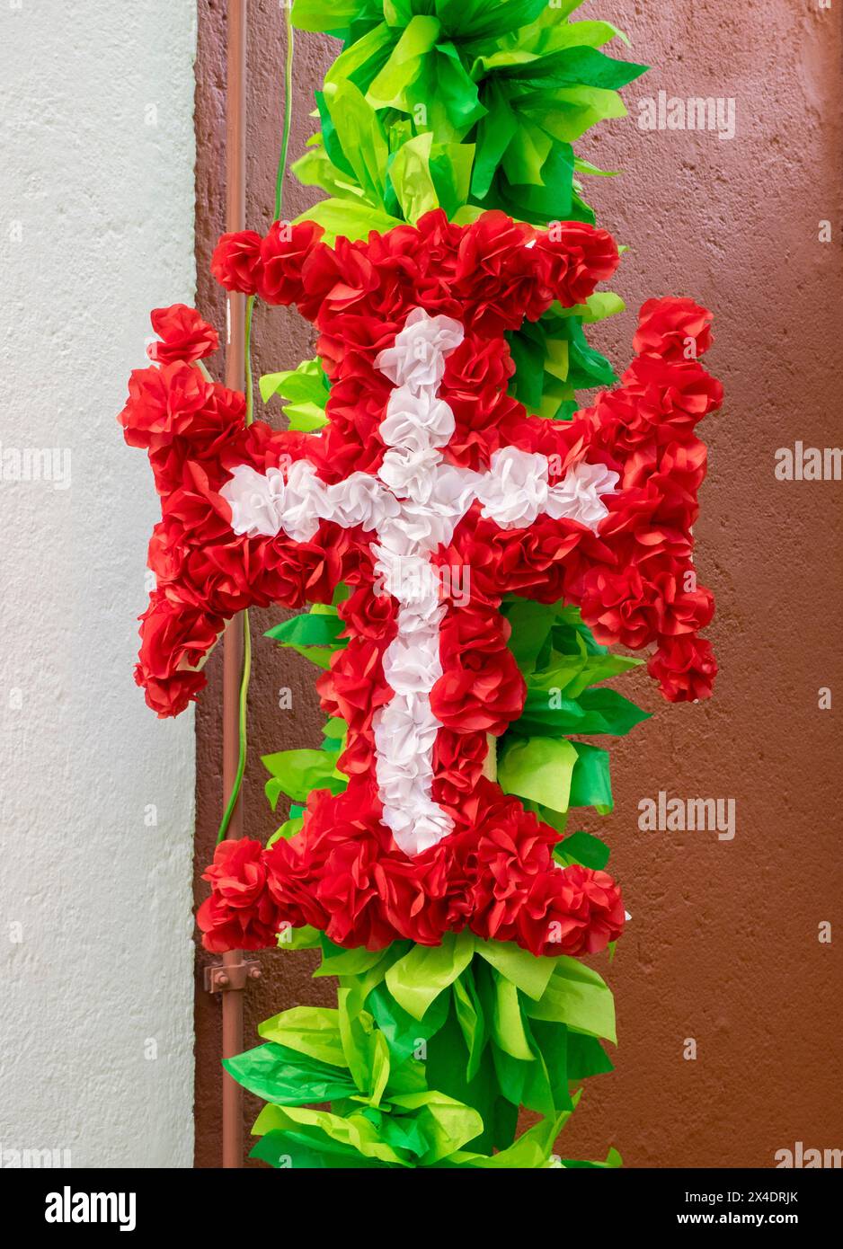 Colorful paper flowers form a Maltese cross during the Festa dos ...