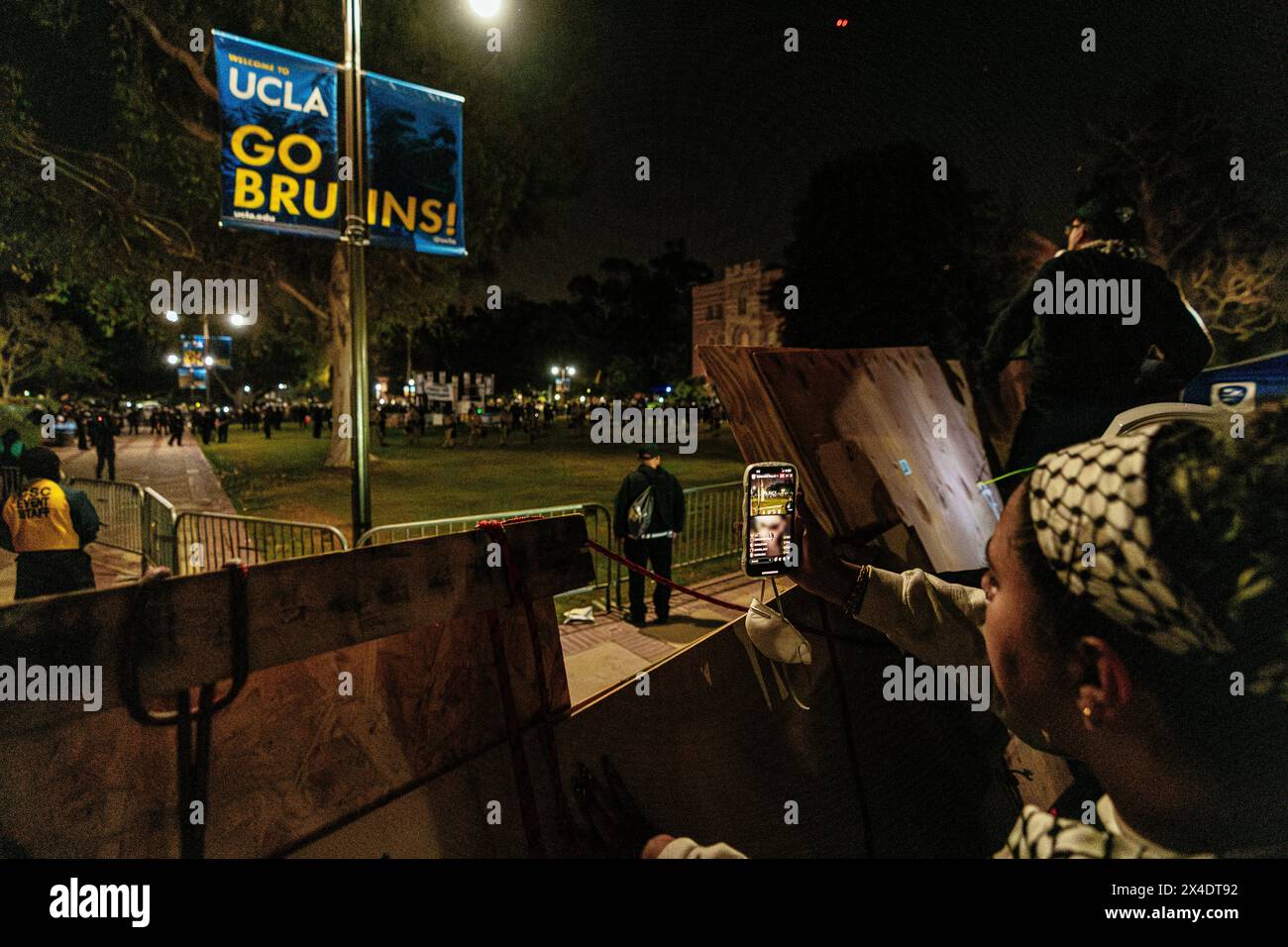 Pro-Palestinian protesters look on at area police forces from the ...