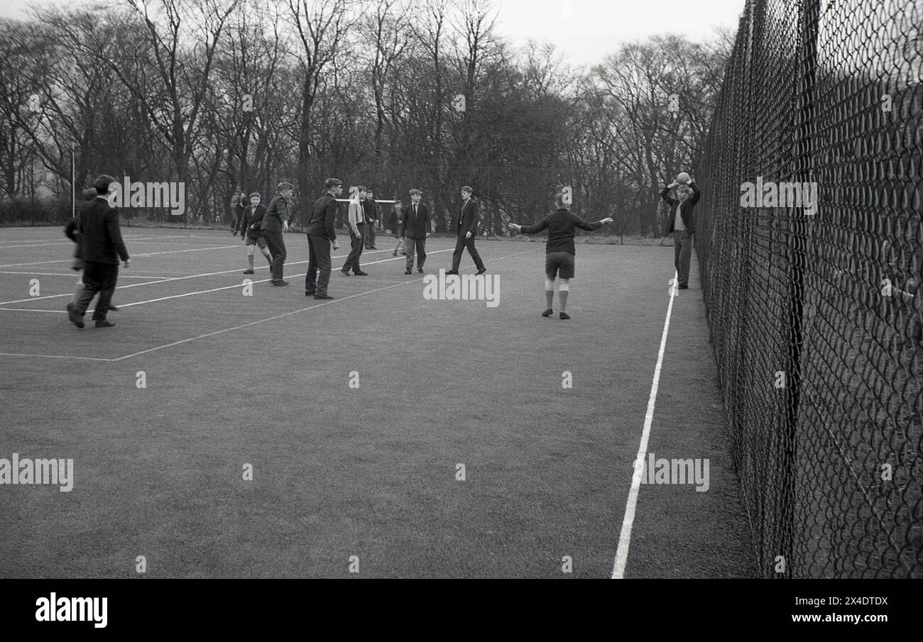 1960s, historical, secondary schoolboys playing football in playground ...