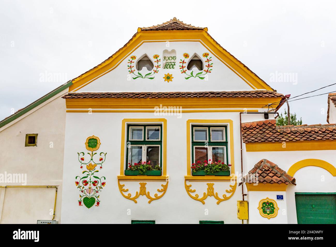 Romania, Transylvania. Colorful, white and yellow stenciled house. 1777 ...