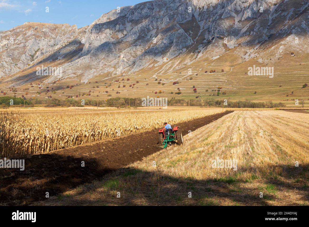 Romania, Transylvania. Tractor plowing fields before planting ...