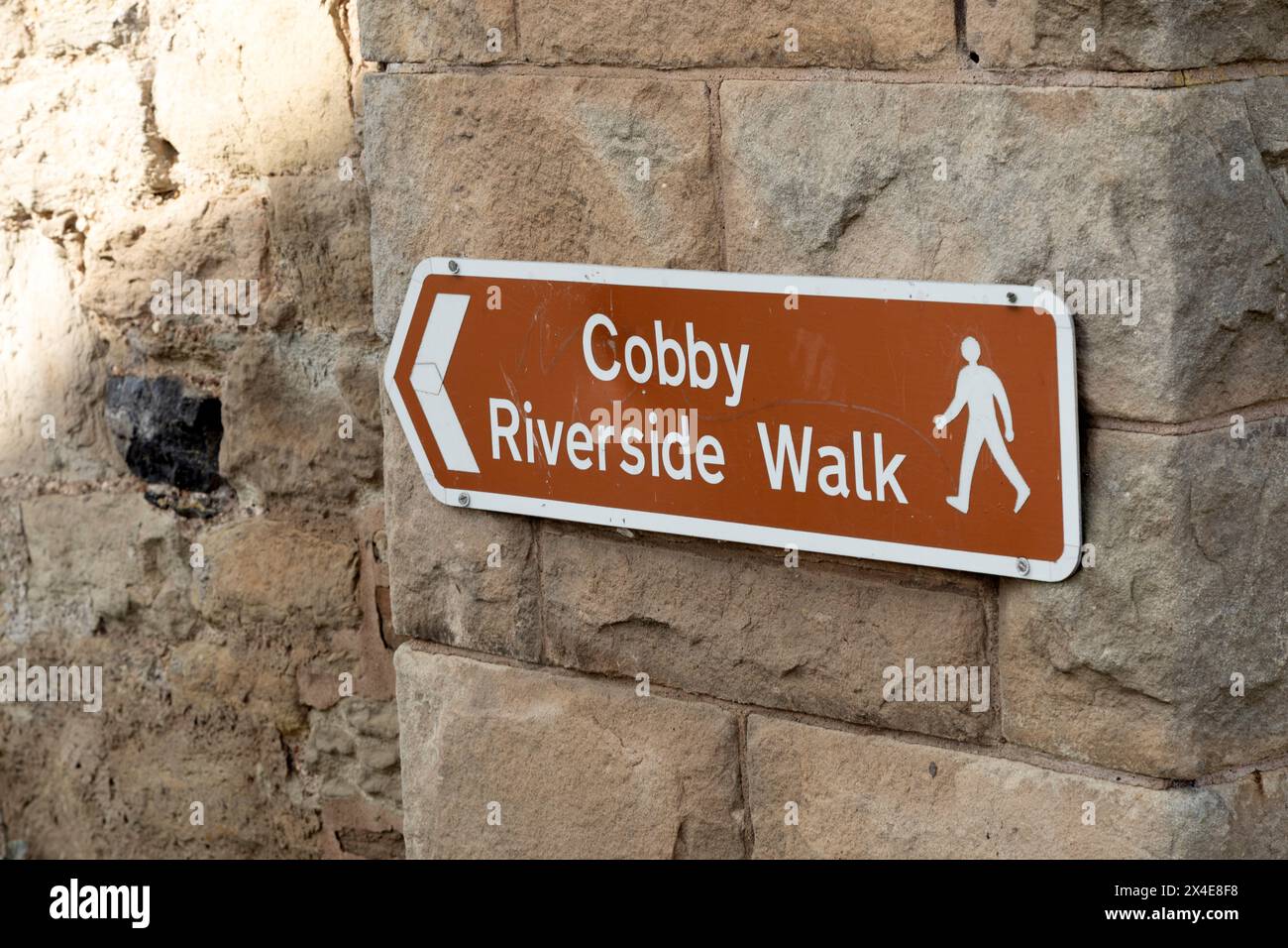 Sign for the Cobby Riverside Walk in Kelso, Scotland. The Cobby runs ...