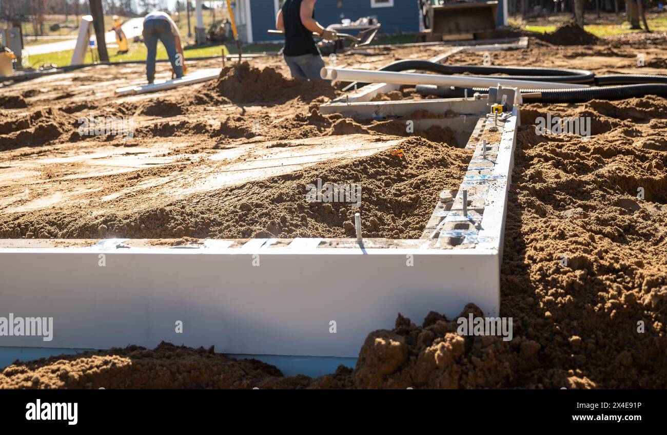 New home construction site with concrete block wall foundation and two ...
