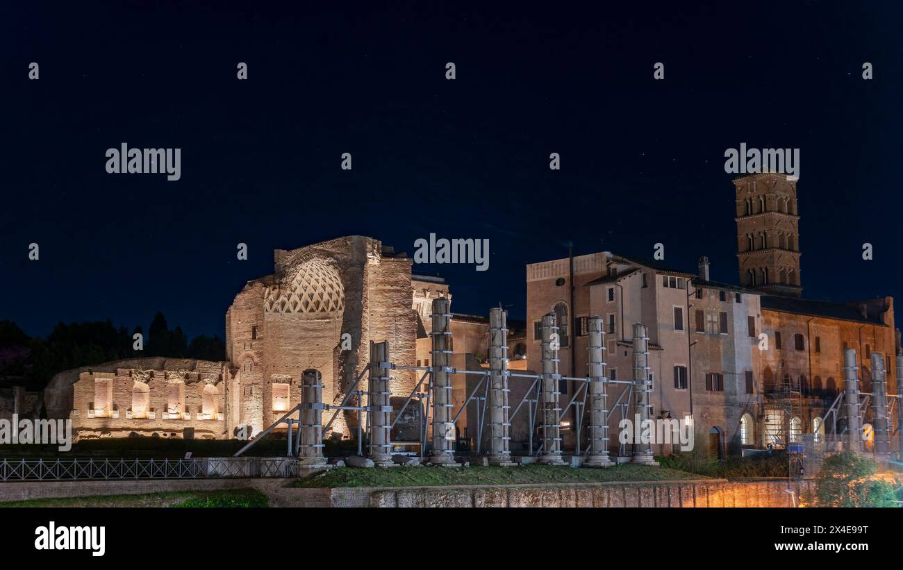 Night view of ancient Roman ruins with illuminated structures and a ...