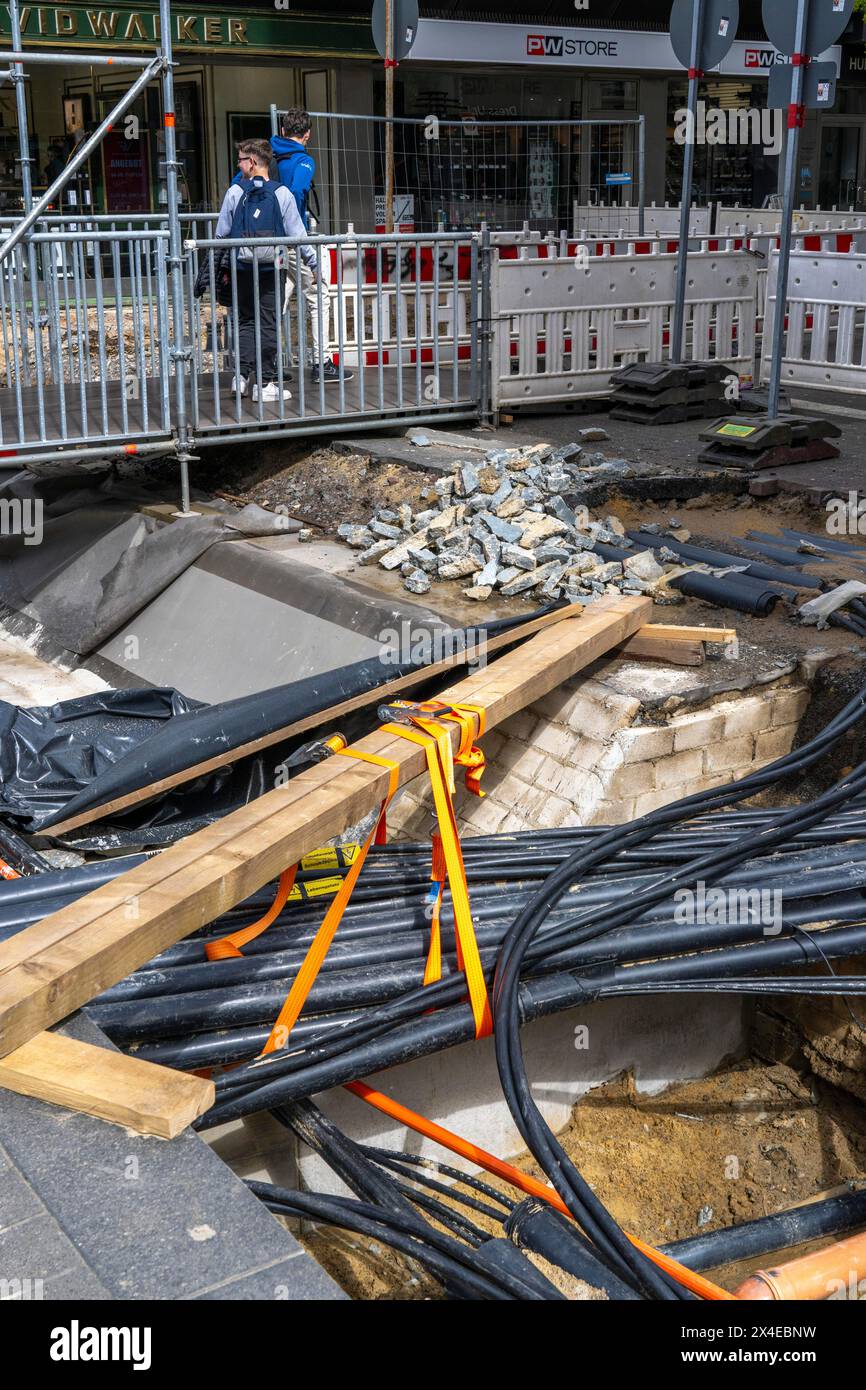 Supply lines, laid underground, are exposed during a construction ...