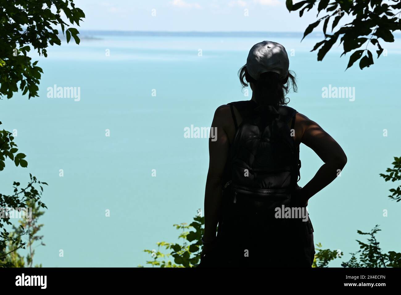 Woman hiking on a path overlooking lake Balaton on Tihany peninsula ...