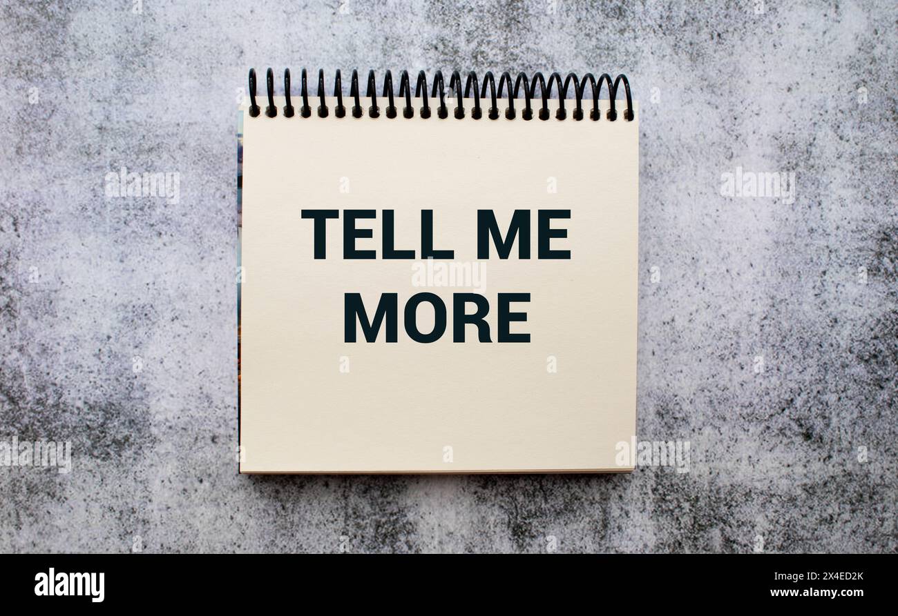 Tell me more symbol. Concept words Tell me more on wooden notebook ...