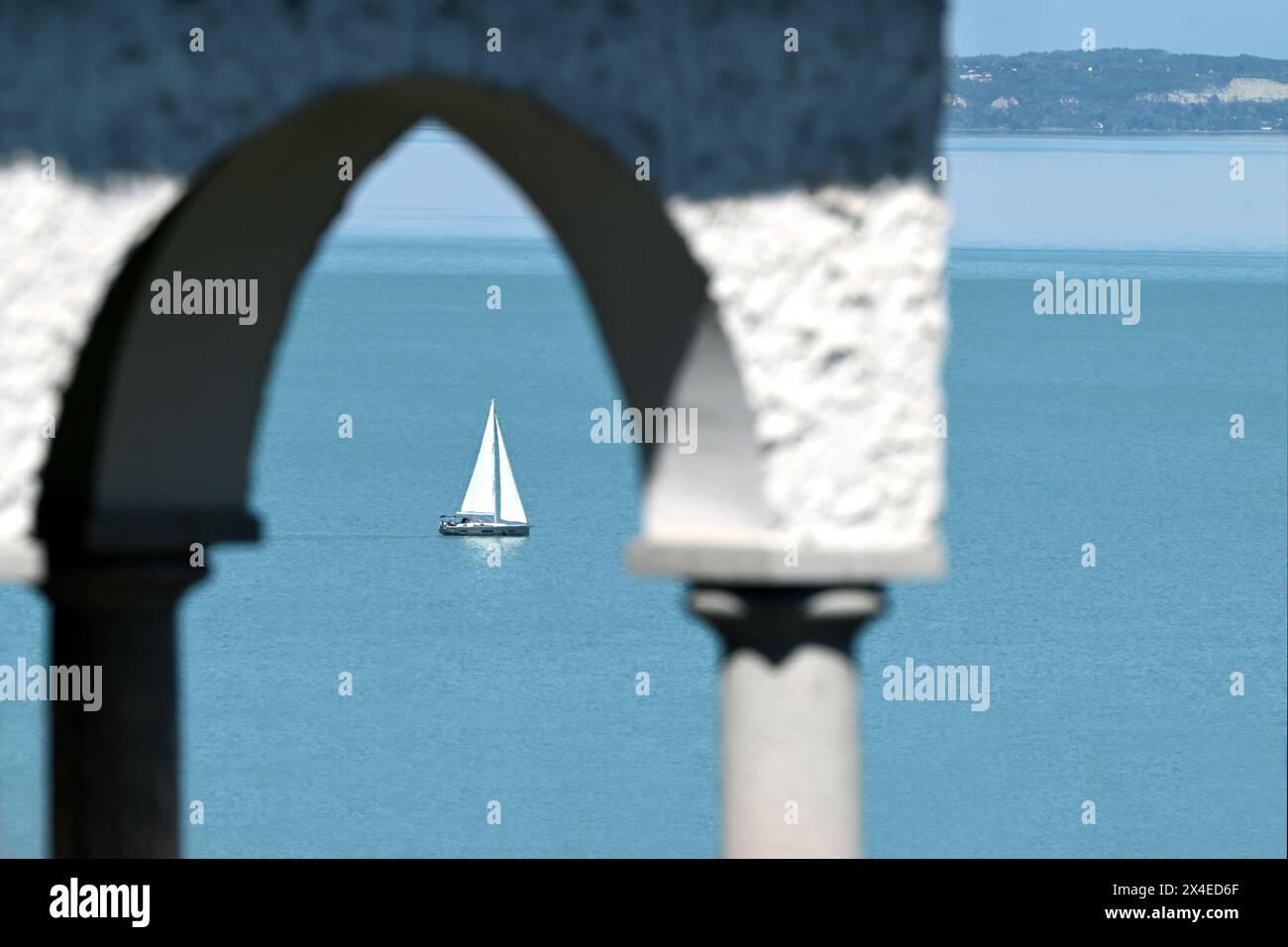 White sailing boat on lake Balaton through an arch structure from ...