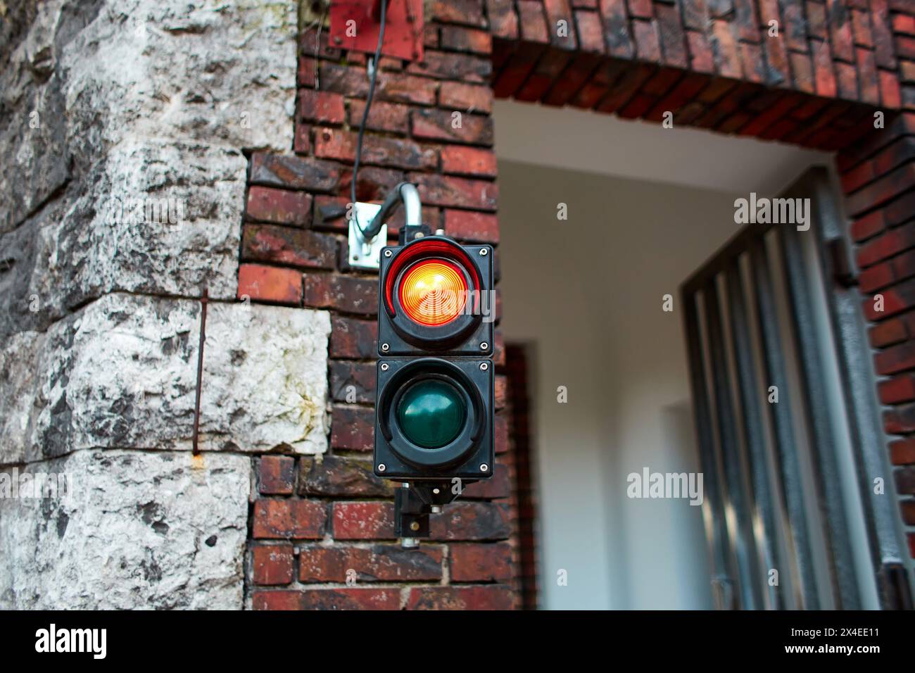 An old vintage pedestrian traffic light on the wall of a brick building ...