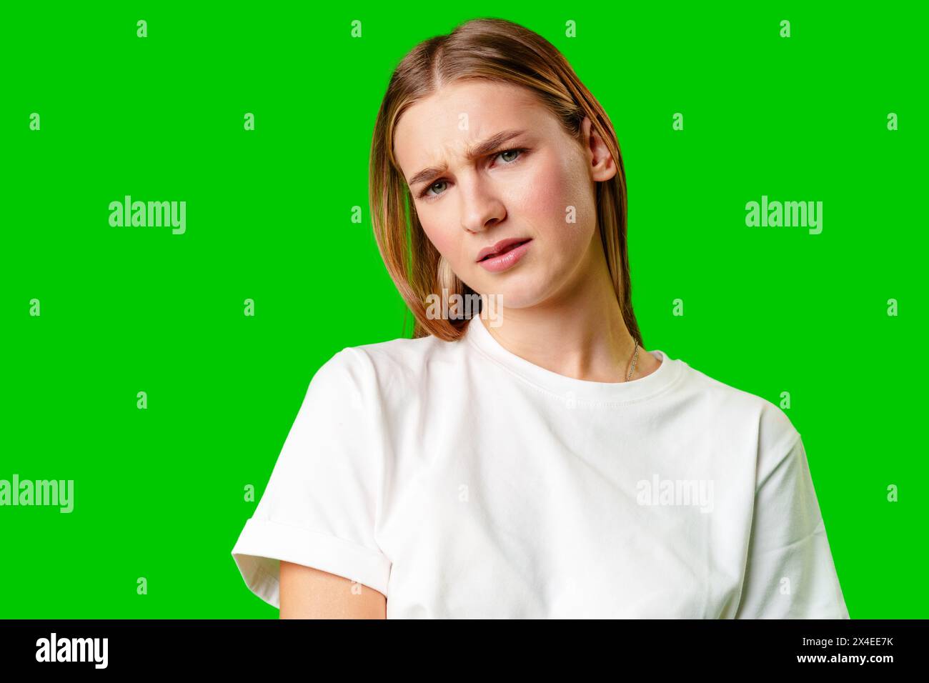 Young Woman With Pursed Lips Expressing Skepticism Against Green Screen ...