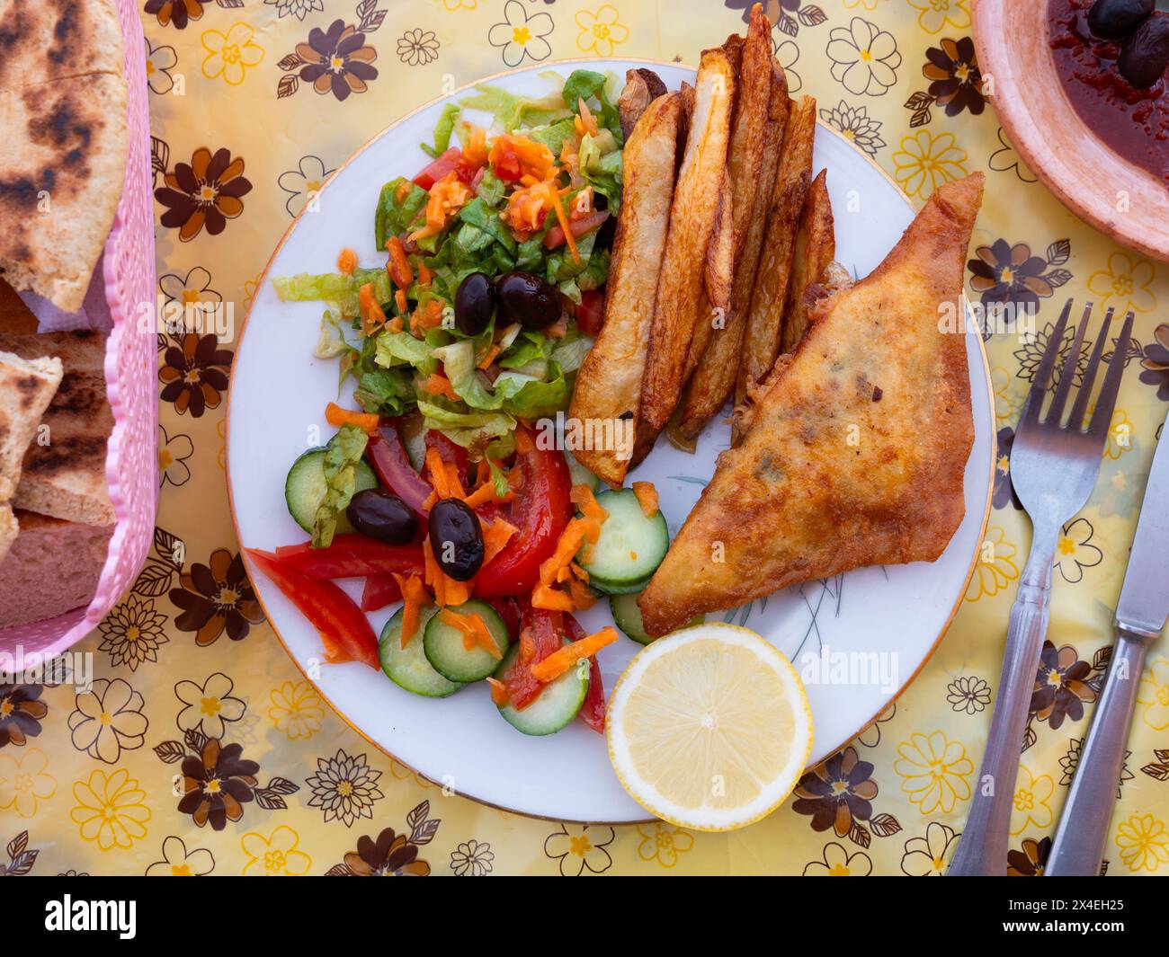 Tunisian brik pie served with vegetable salad Stock Photo - Alamy