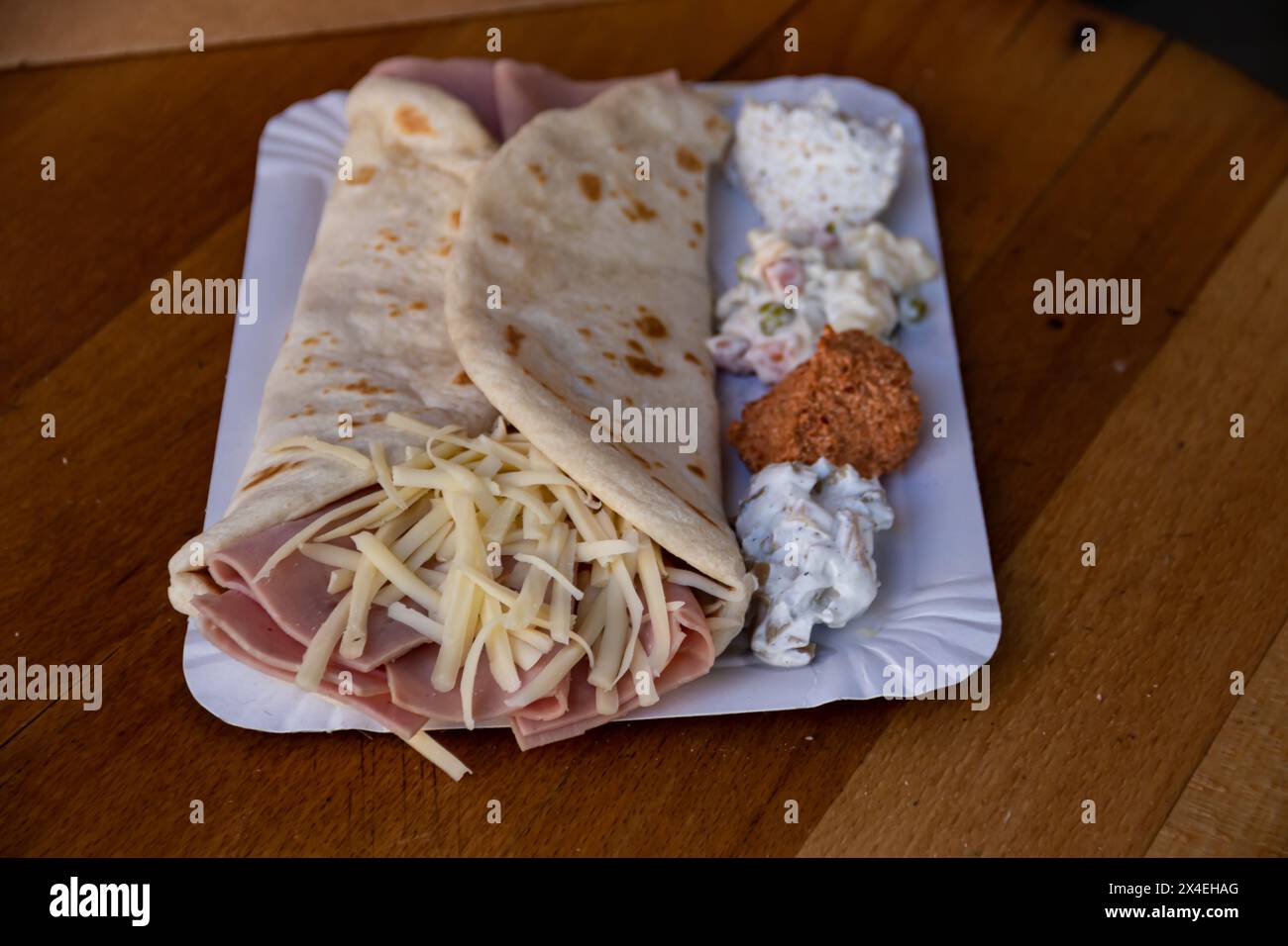 A savory golden pancake filled with ham and melted cheese offers a ...