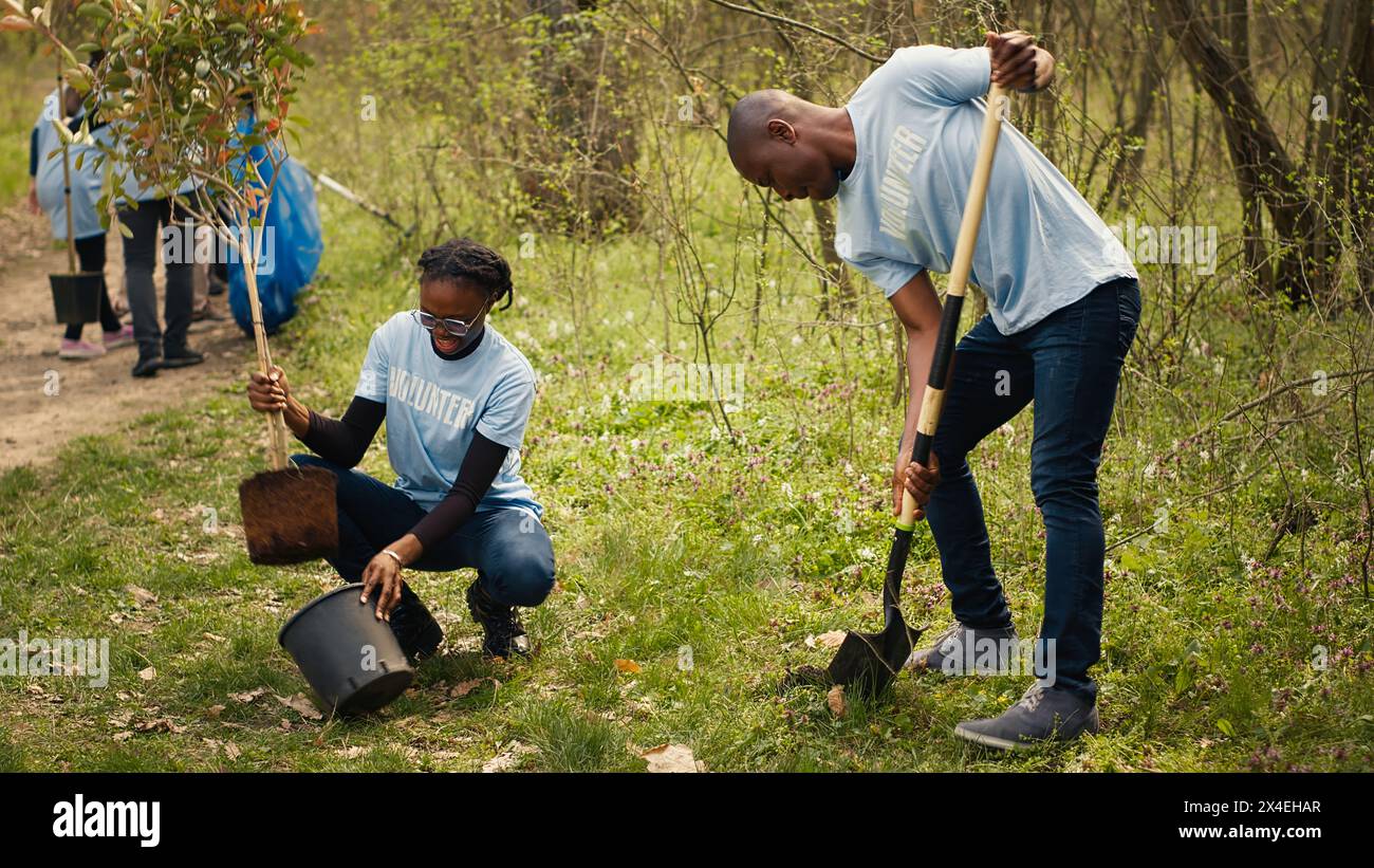 Team of activists planting trees to conserve natural ecosystem and ...