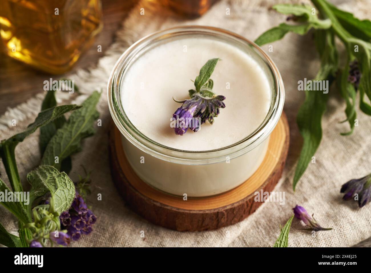 Comfrey root ointment in a glass jar on a table Stock Photo - Alamy