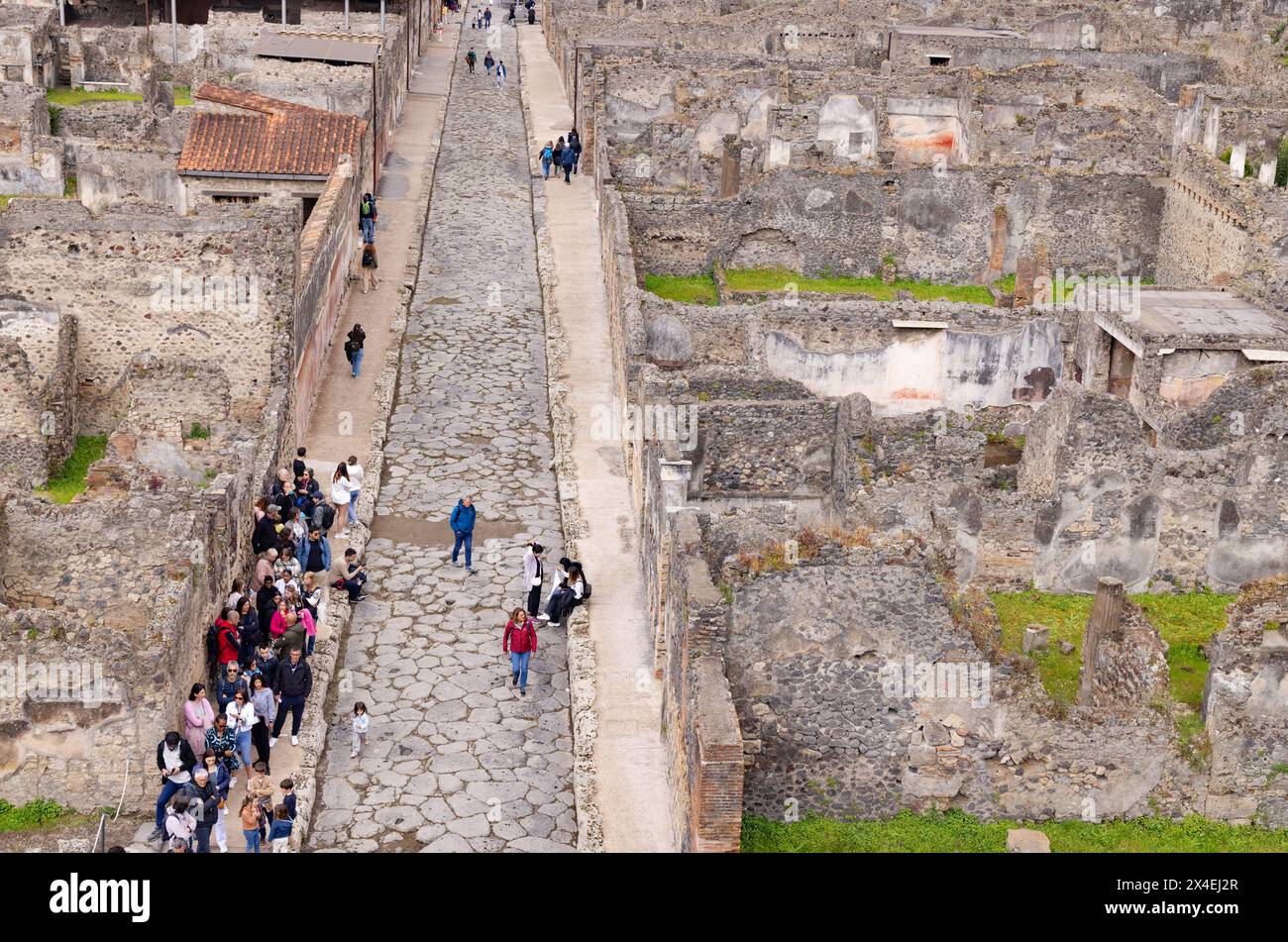 Pompeii tourists - a view of people from above walking along one of the ...