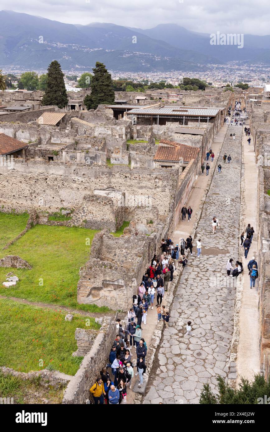 Pompeii tourists - a view of people from above walking along one of the ...