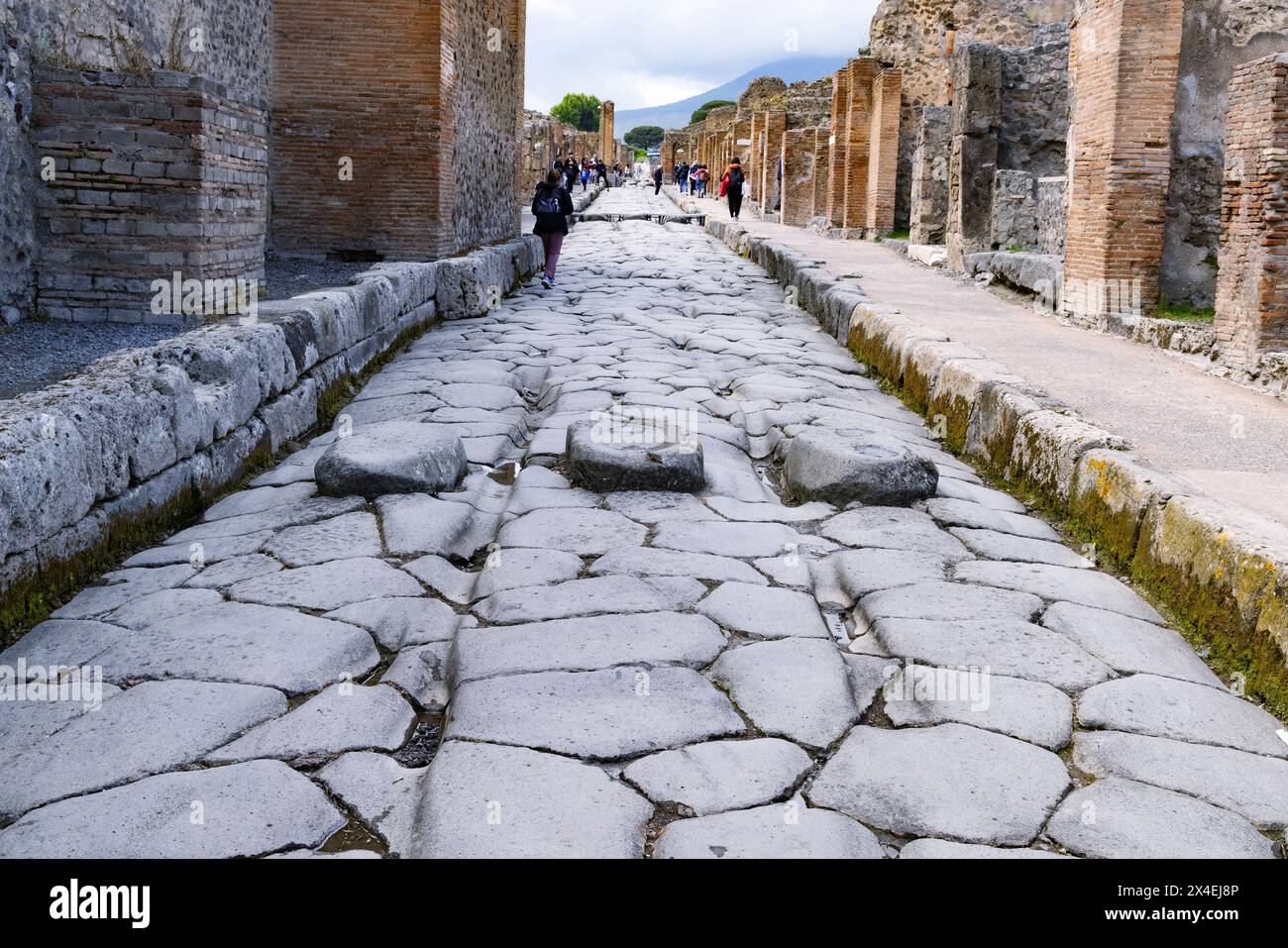 Roman road Pompeii ruins, showing pedestrian crossing and wheel ruts ...