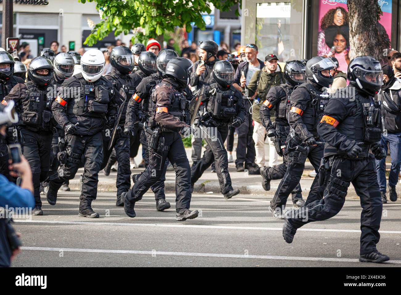 Paris, France. 01st May, 2024. A squad of the Brav-M, french riot police, seen running to ...