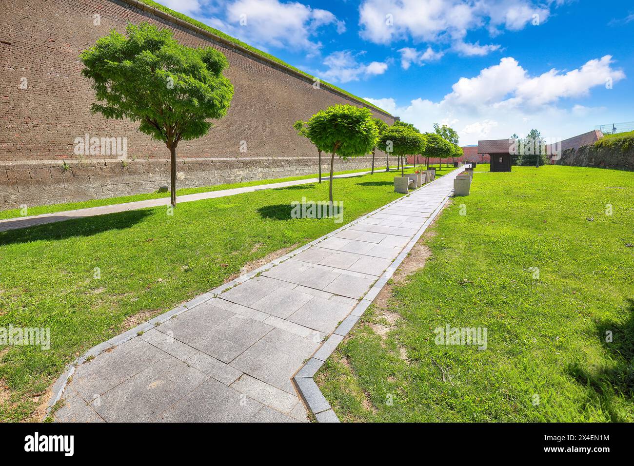 Amazing cityscape and aged medieval defense fortification walls with green lawn in medieval ...