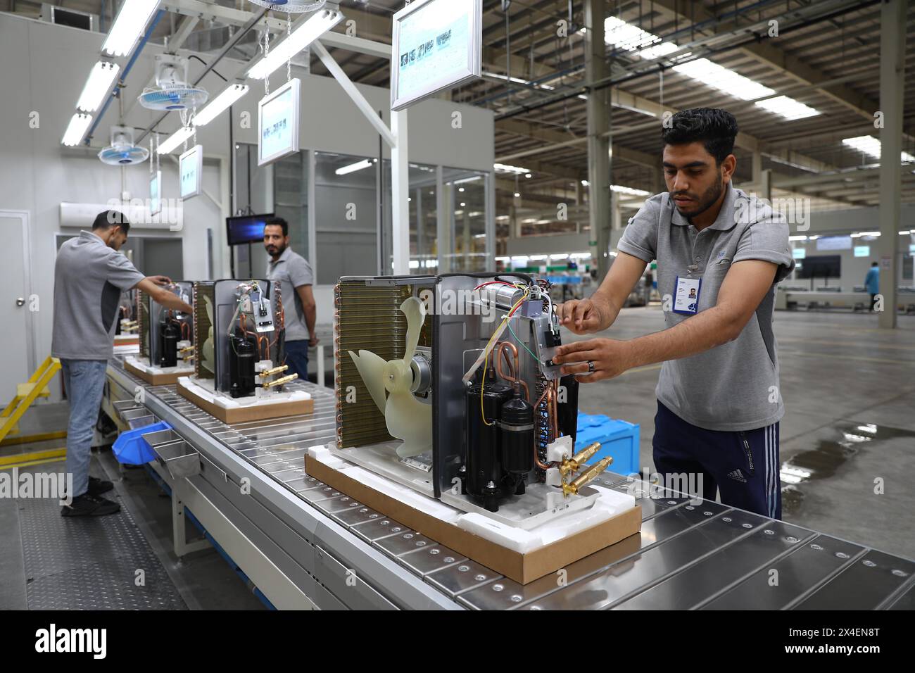 Th Of Ramadan City. 2nd May, 2024. Laborers work on an air-conditioner ...